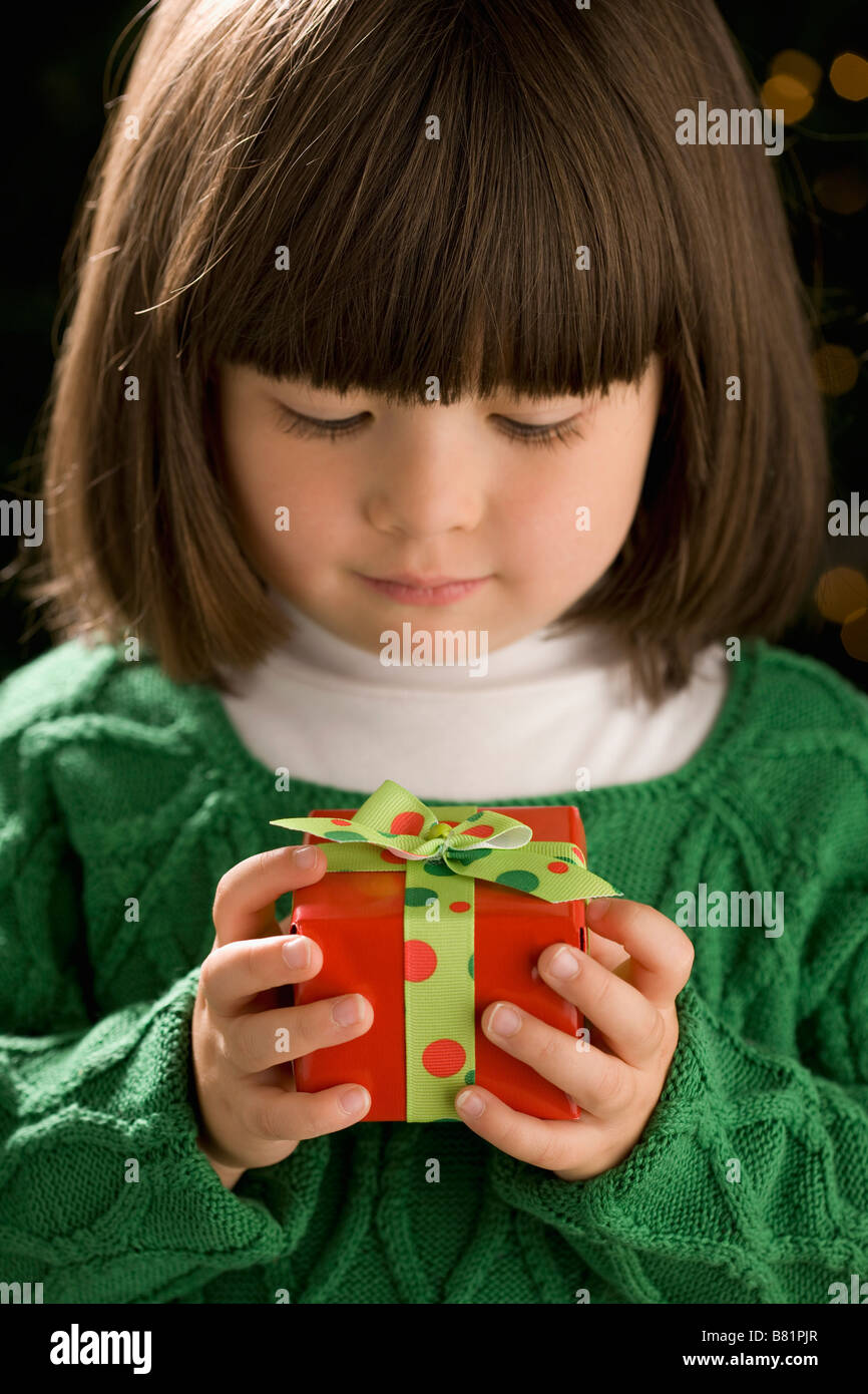Little girl holding a present Stock Photo - Alamy