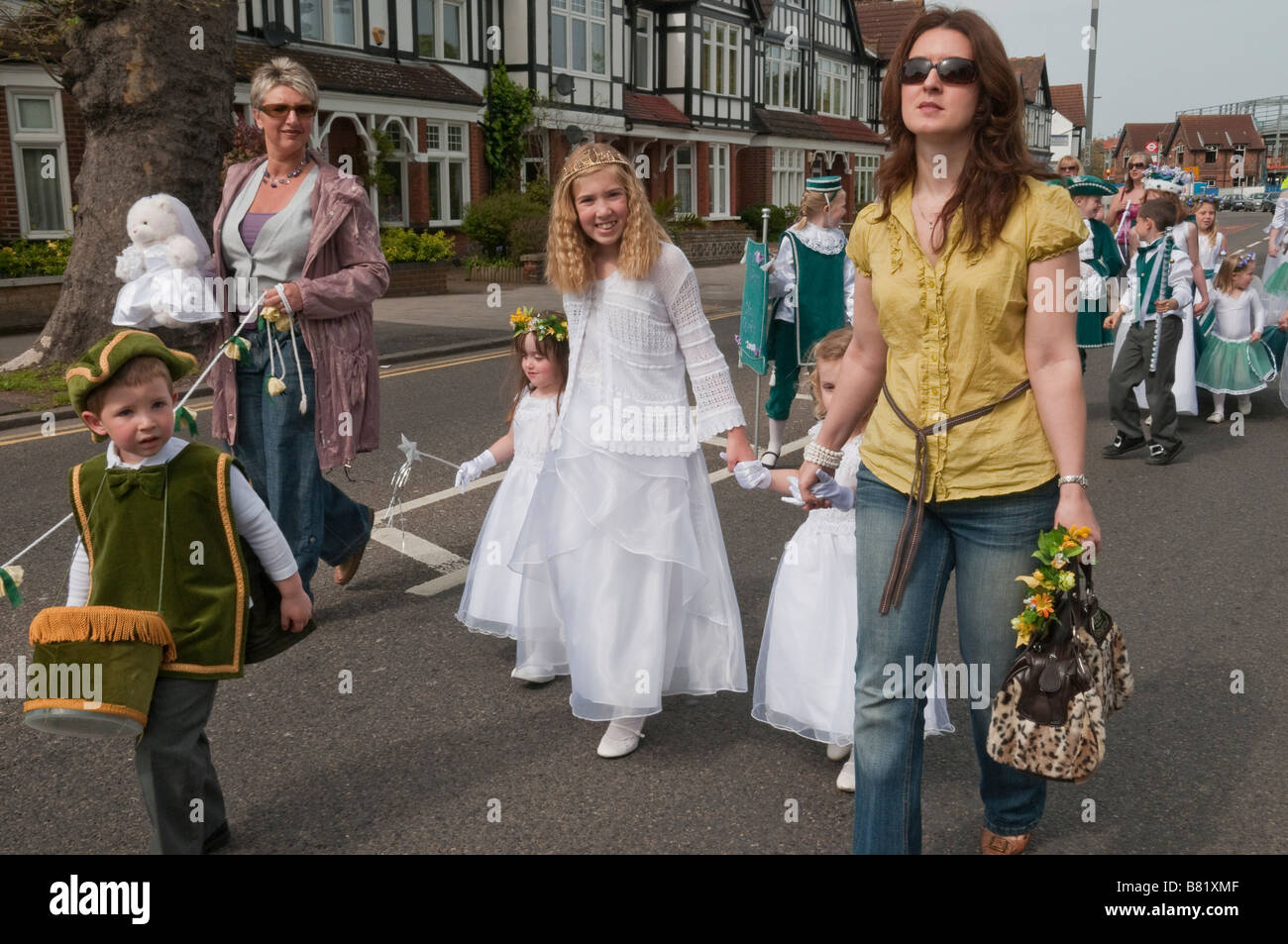 A May Queen procession with Page Boy, Queen, attendants and mothers on ...