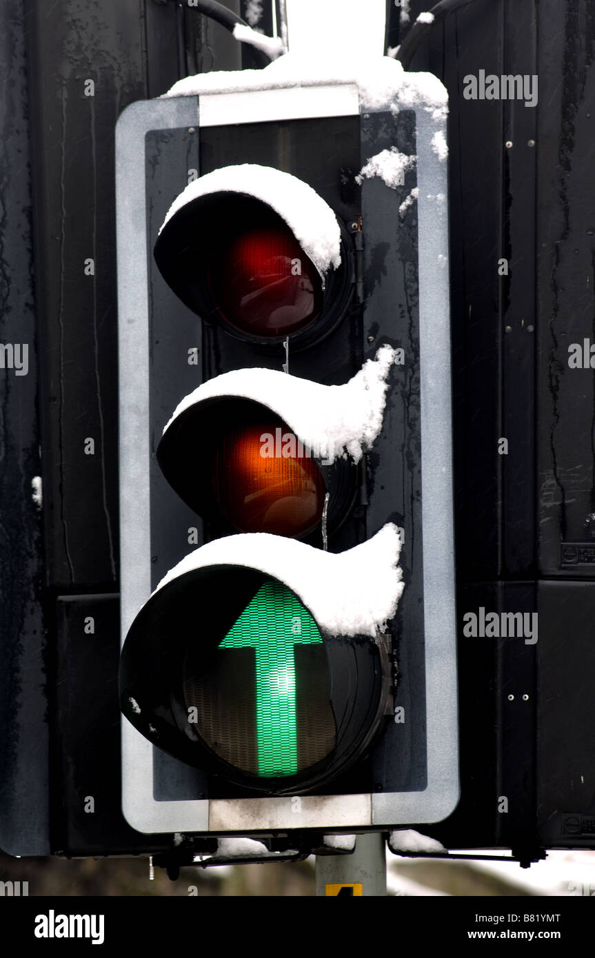 Traffic lights, with snow, on green, UK Stock Photo - Alamy