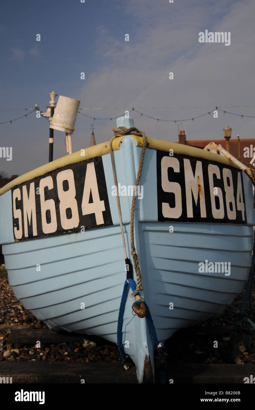 A small light blue fishing boat on the beach at Worthing on the English ...