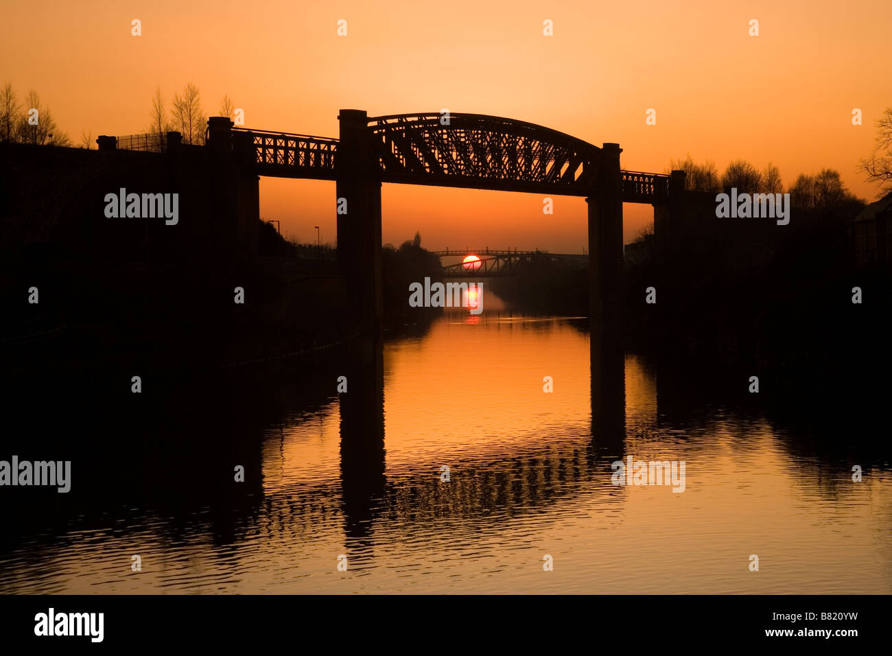 Manchester Ship Canal at sunset with Latchford Railway Viaduct in ...