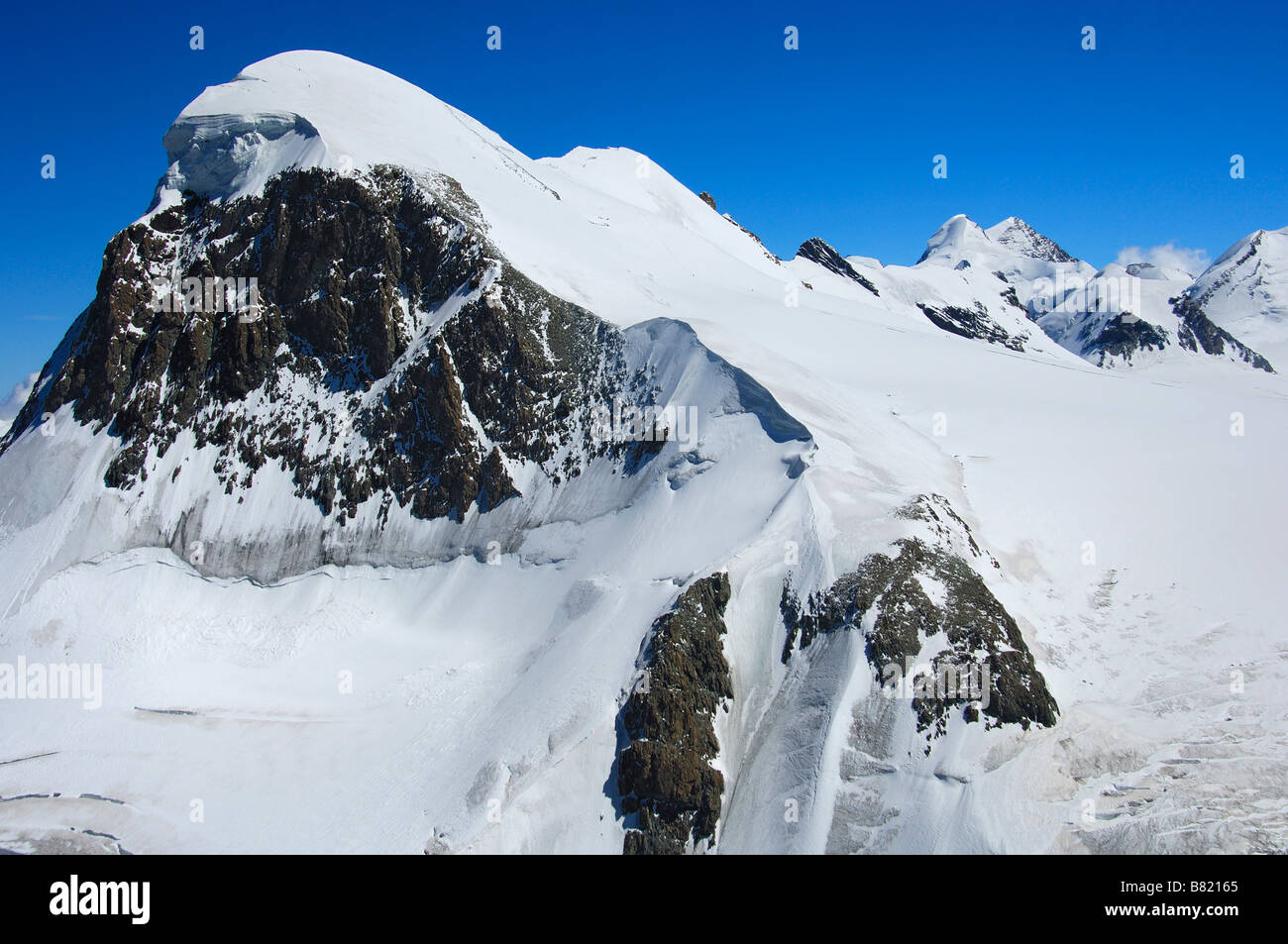 Summit of Mount Breithorn with its thick snow cap, peaks Castor and ...