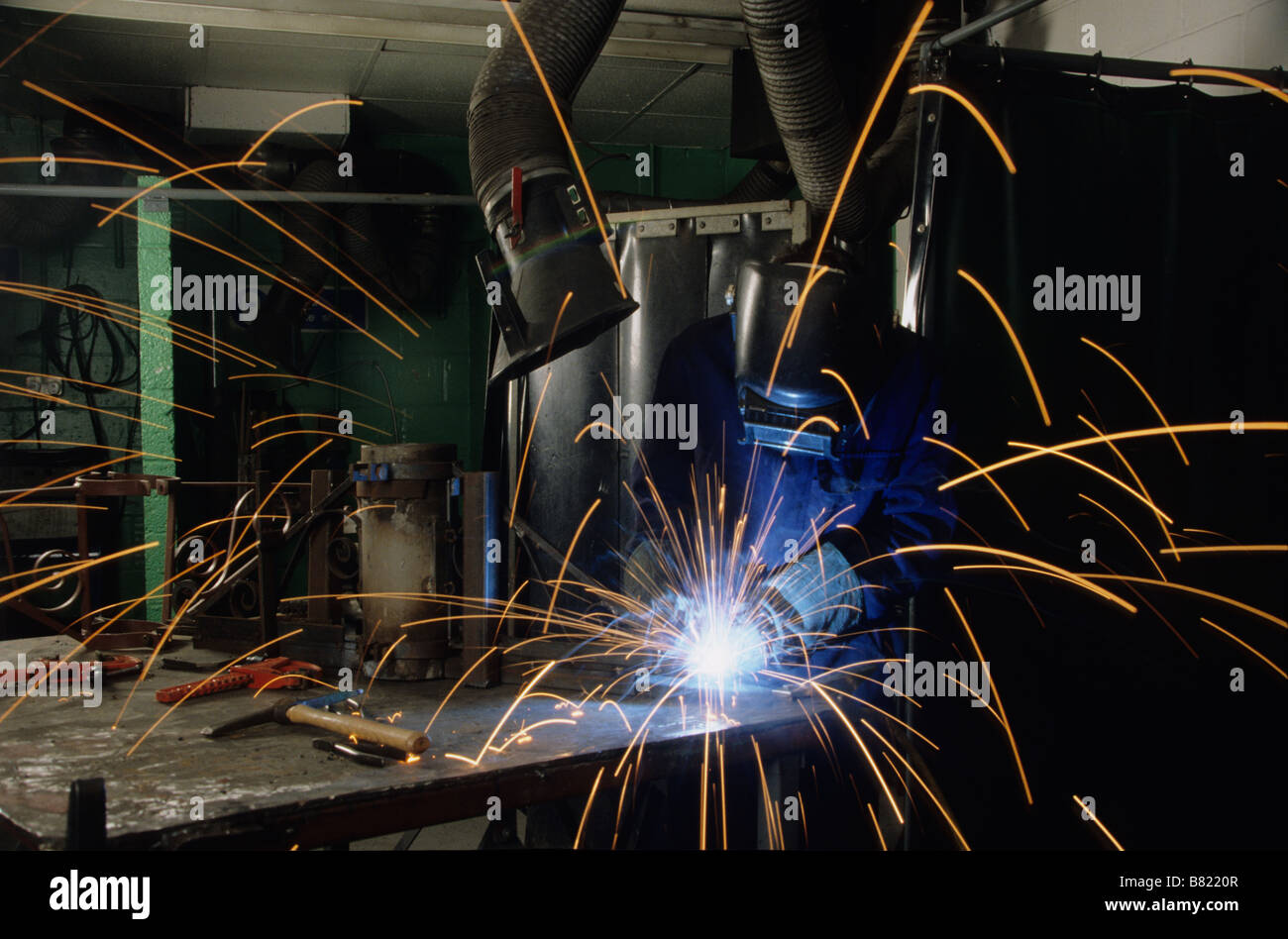 welder at work bench creating sparks Stock Photo - Alamy