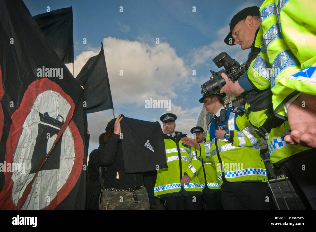 Fitwatch banner facing police Forward Intelligence team with cameras to ...
