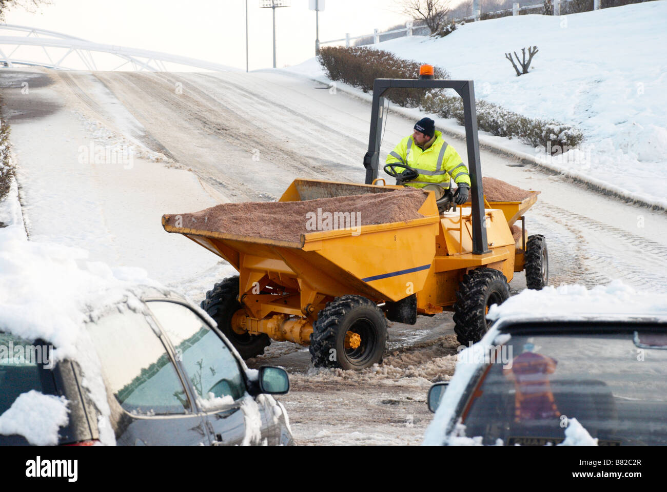 mini dumper gritting the road Stock Photo - Alamy