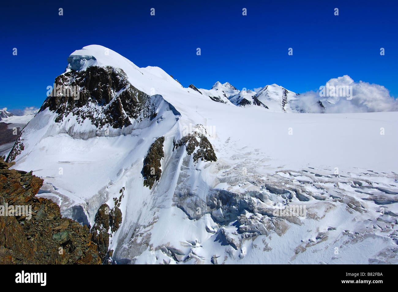 Summit of Mount Breithorn with its thick snow cap, peaks Castor and ...