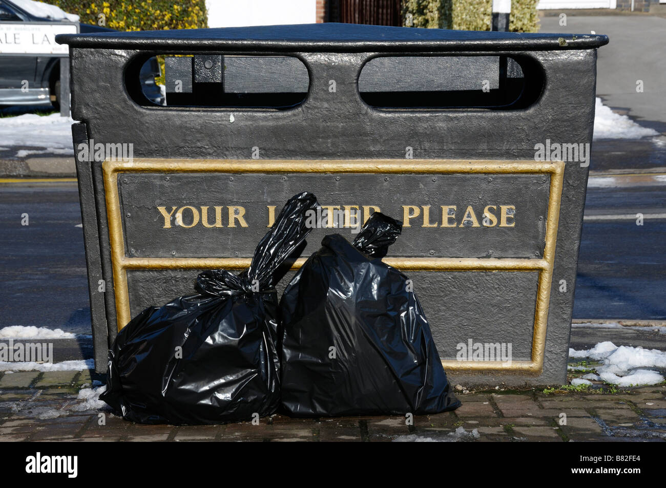 Stock photo of black bin bags full of rubbish left out next to a public ...