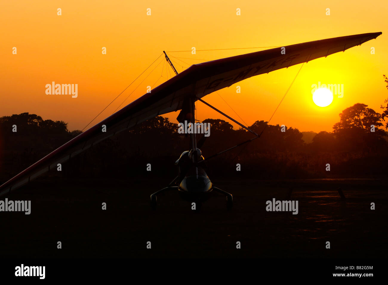 fixed wing microlight aircaft withe setting sun background Stock Photo ...