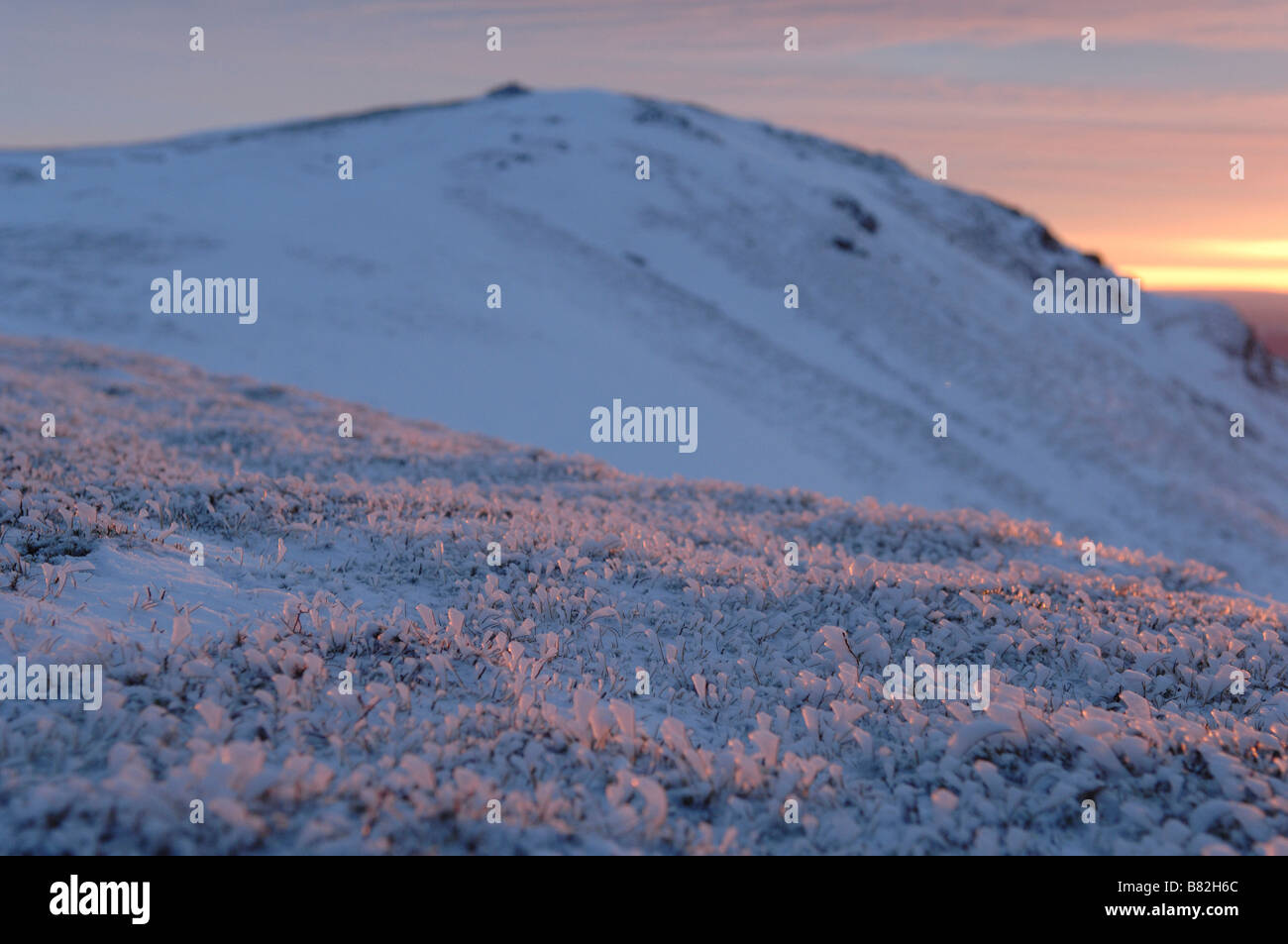 Snow and ice covered ground at dawn with Blencathra summit in the ...
