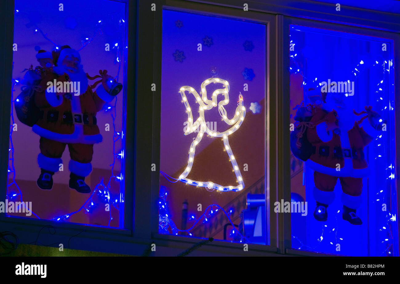 ILLUMINATED CHRISTMAS WINDOW WITH BLUE LIGHT STRINGS DURING ADVENT TIME ...