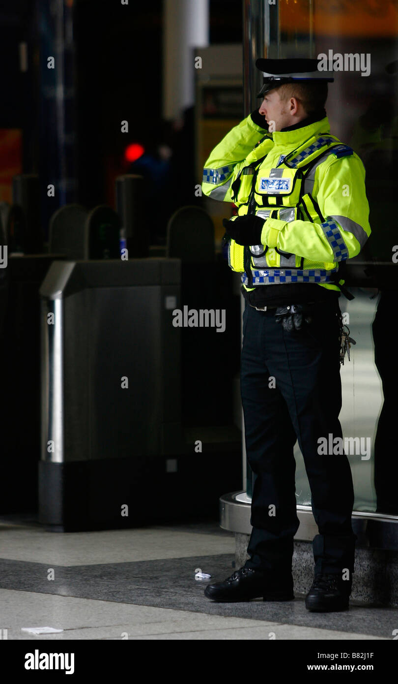 A Police Community Support Officer or PCSO watches commuters at London ...