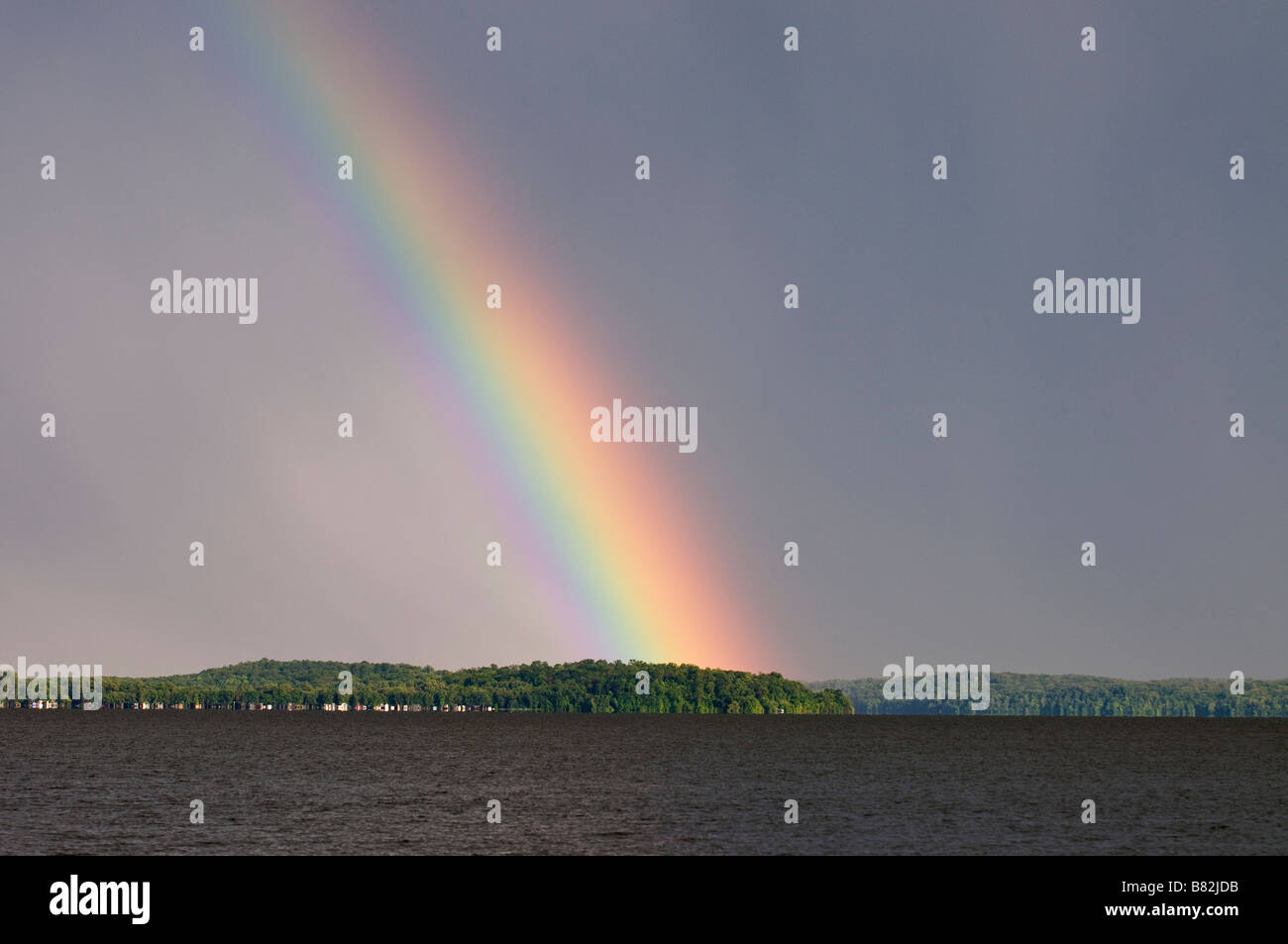 Rainbow breaks through rain storm at sunset Big Pine Lake Minnesota ...