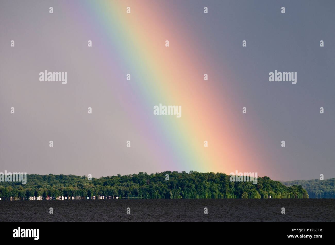 Rainbow breaks through rain storm at sunset Big Pine Lake Minnesota ...