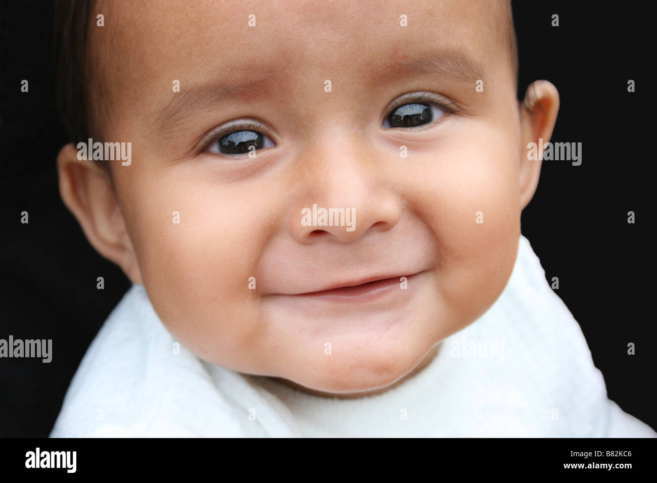 Baby looking at camera smiling Stock Photo - Alamy