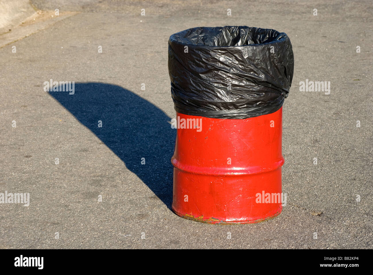 Red barrel used as garbage can Stock Photo - Alamy