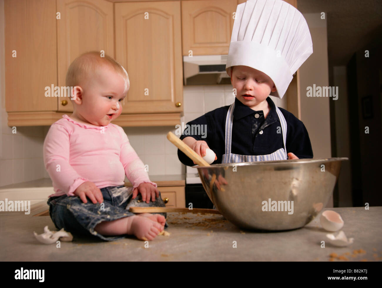 Children playing in the kitchen Stock Photo - Alamy