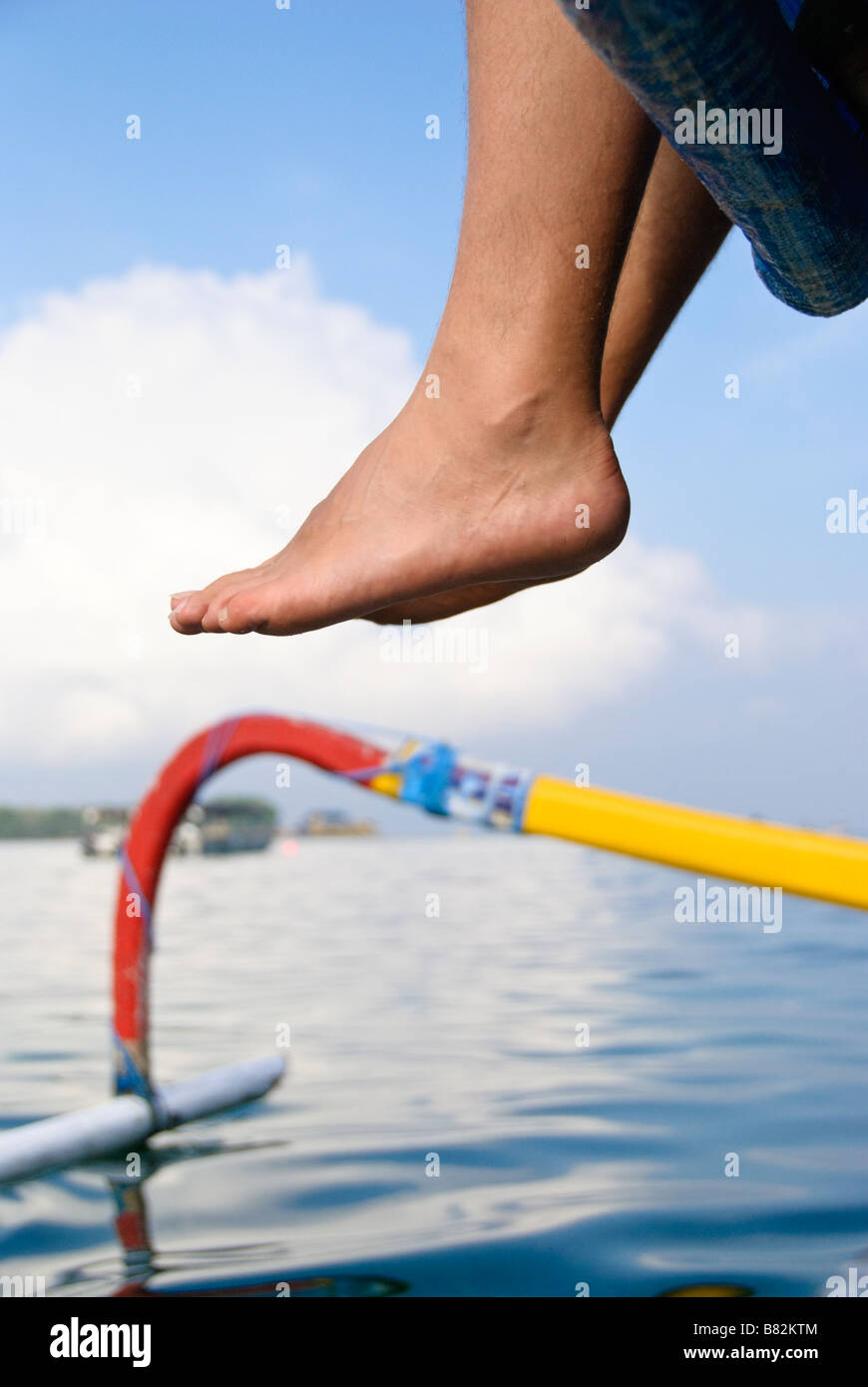 Feet dangled off top deck of a boat leaving Nusa Lembongan, Bali ...