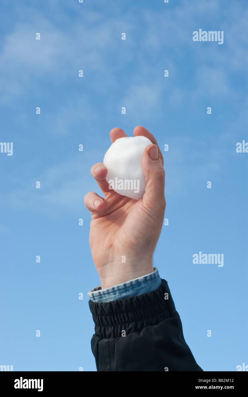 Hand holding snowball, ready to throw Stock Photo - Alamy