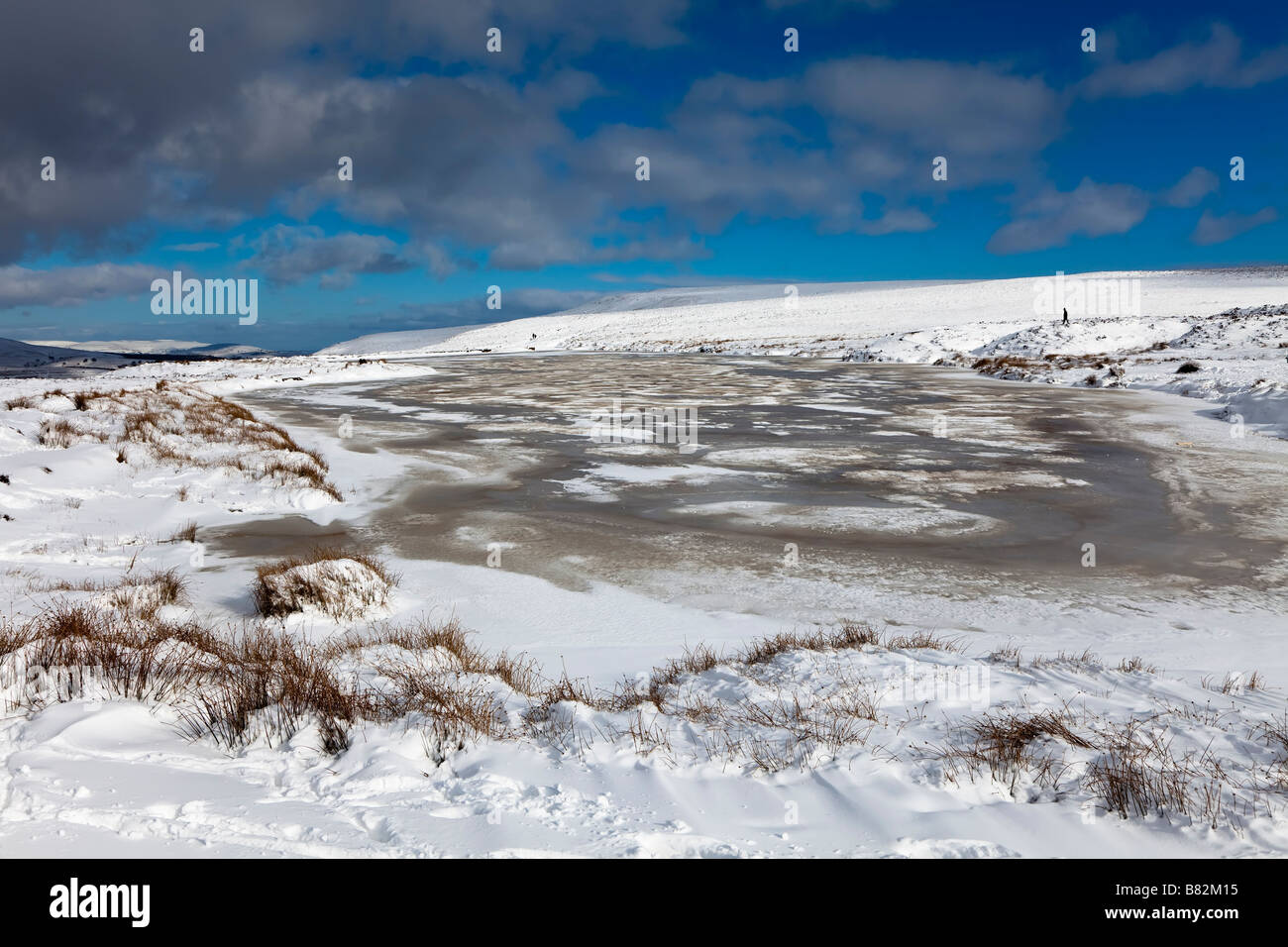Three people walking in distance near frozen lake in winter Keeper's ...