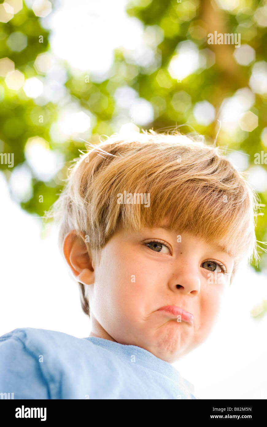 boy showing sad face looking down silly Stock Photo - Alamy