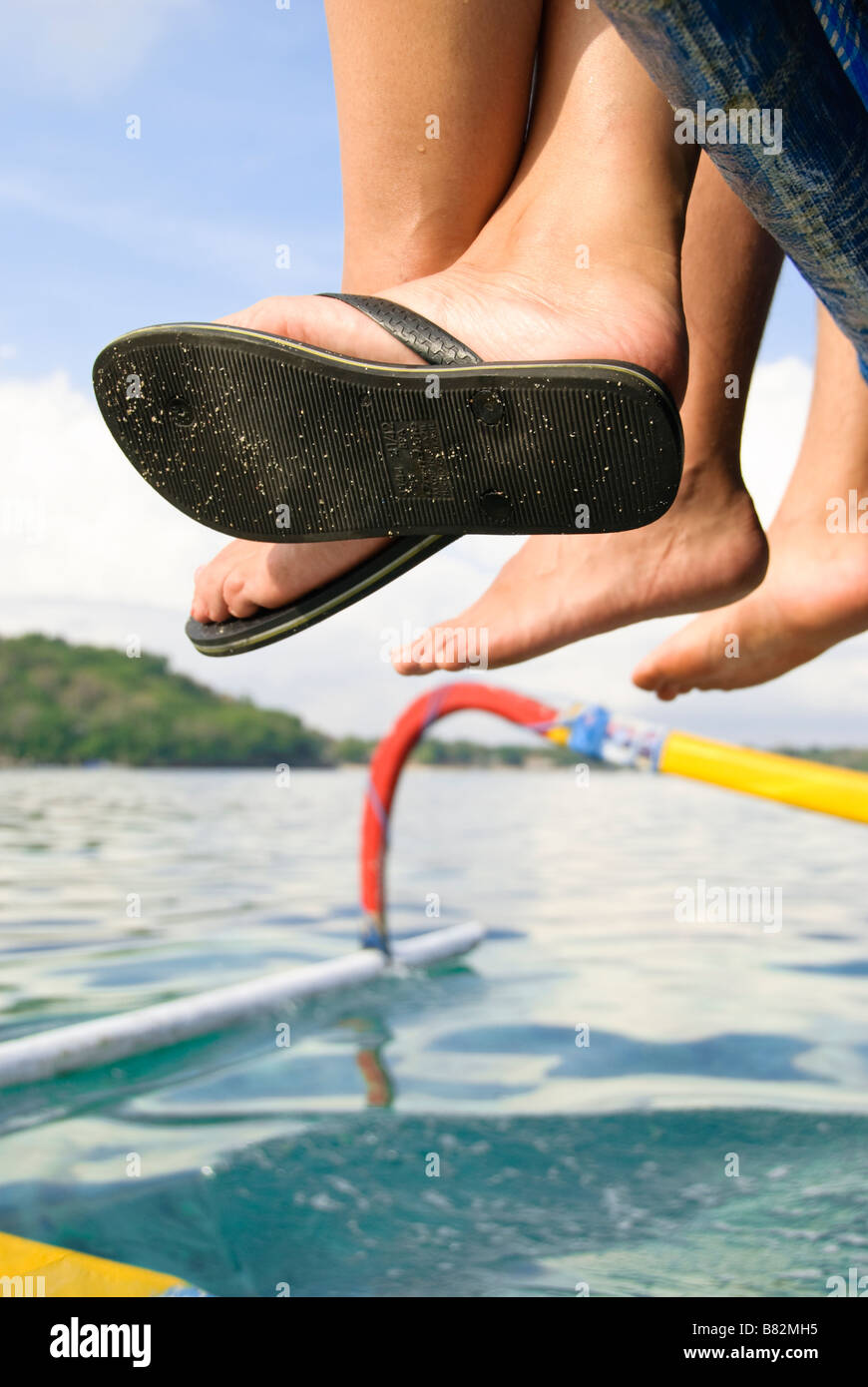 Feet dangled off top deck of a boat leaving Nusa Lembongan, Bali ...