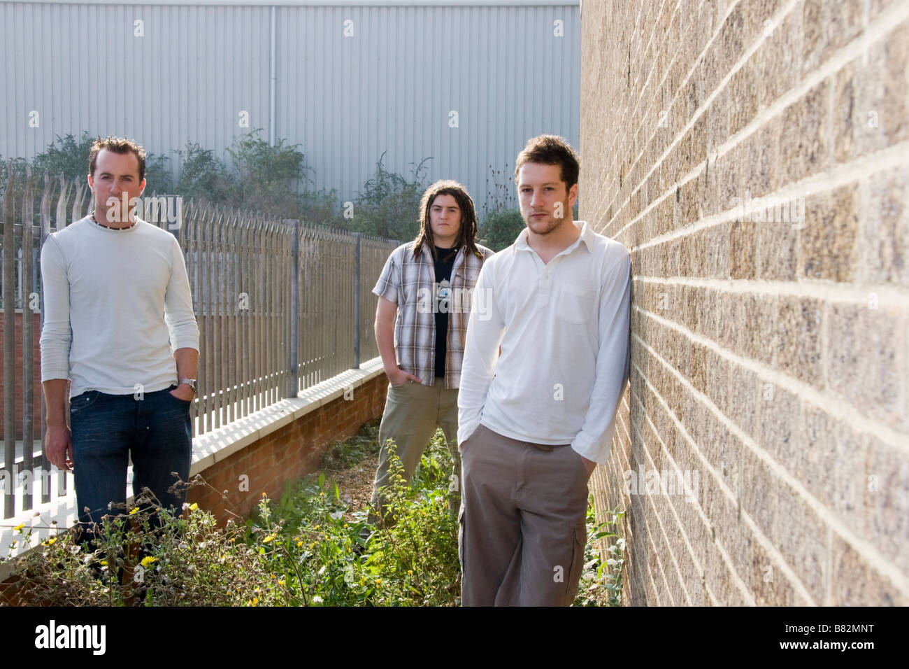 Three young men staring at the camera Stock Photo - Alamy