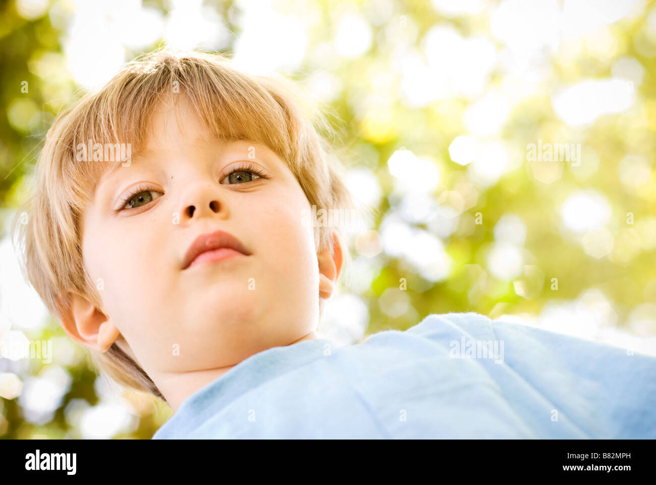 boy looking down thoughtless Stock Photo - Alamy