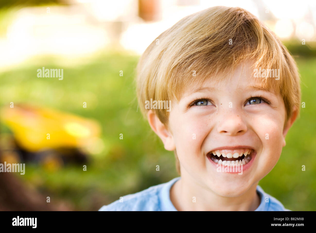 boy laughing outdoors playing Stock Photo - Alamy