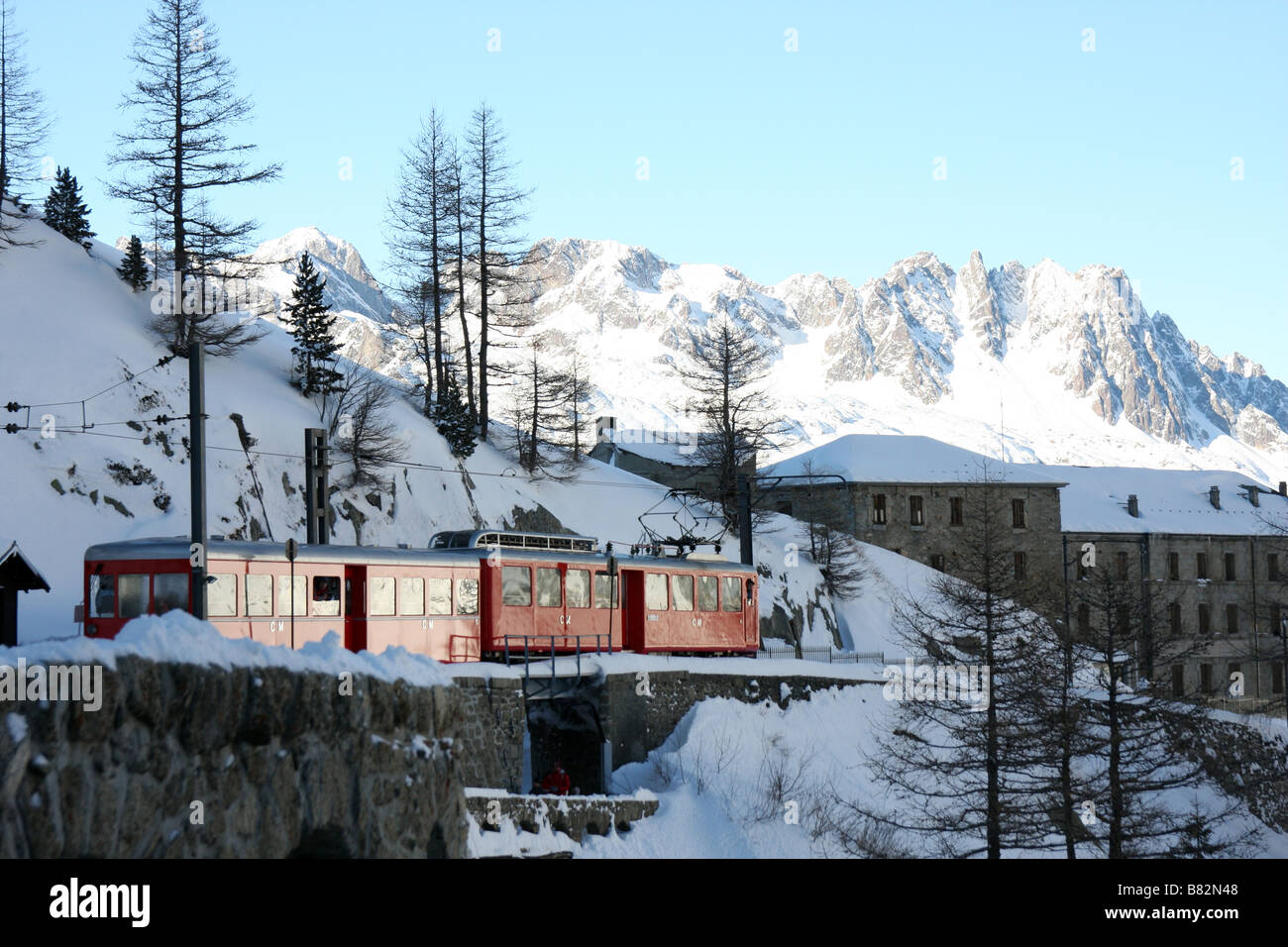 Red rack railway train arriving at the station in Montenvers, next to ...