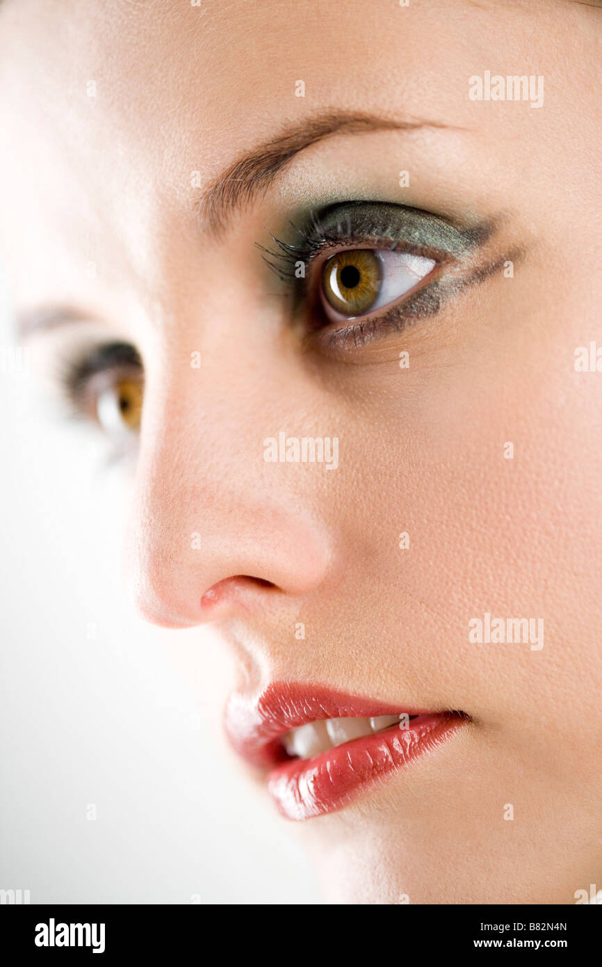 Portrait of young woman with make up side view Stock Photo - Alamy