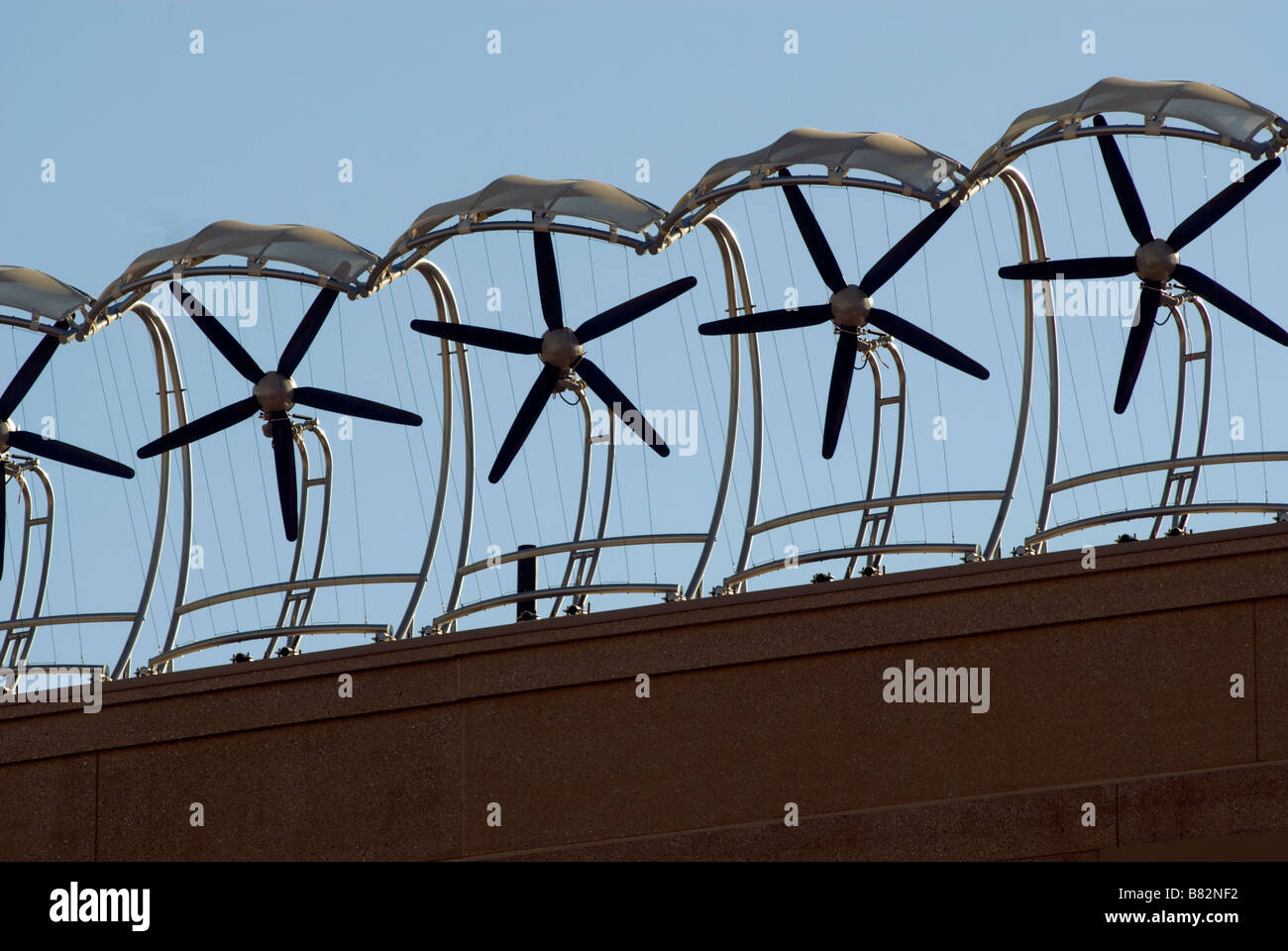Wind turbines are seen on the roof of an apartment building under ...