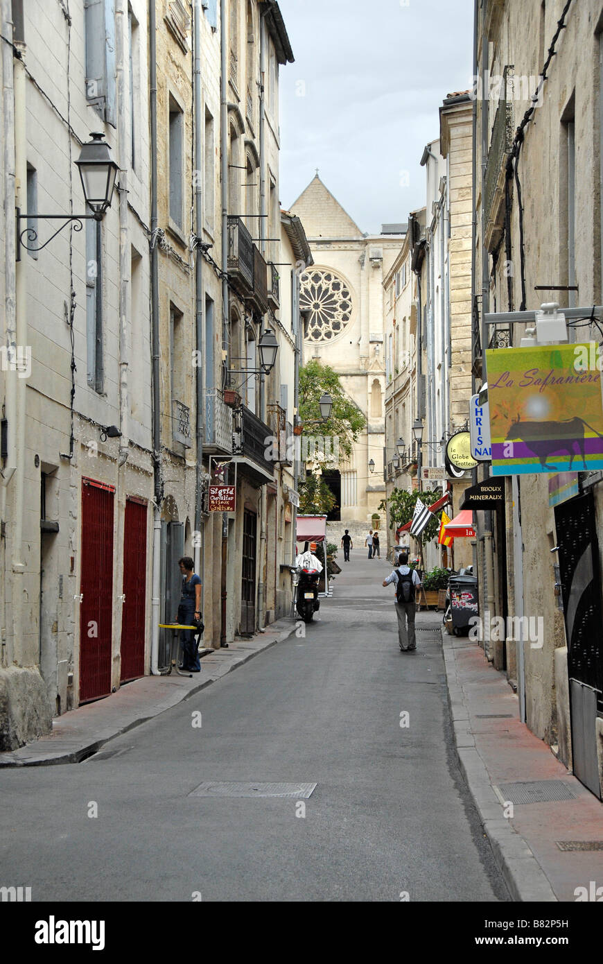 Narrow street with people in the historic old town of Montpellier ...