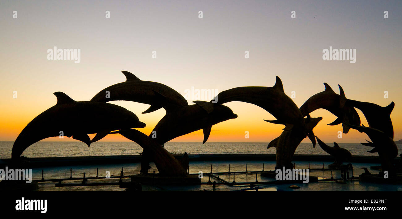 MEXICO SINOLA STATE MAZATLAN Dolphin sculptures silhouetted at sunset ...