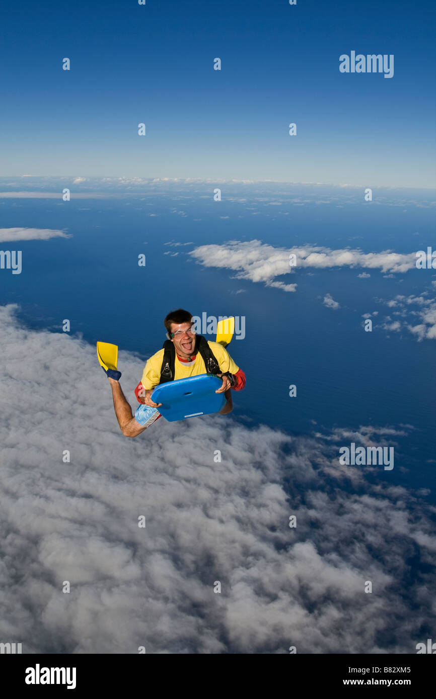 Skydiver is riding the big wave in the sky with a body board over the ...