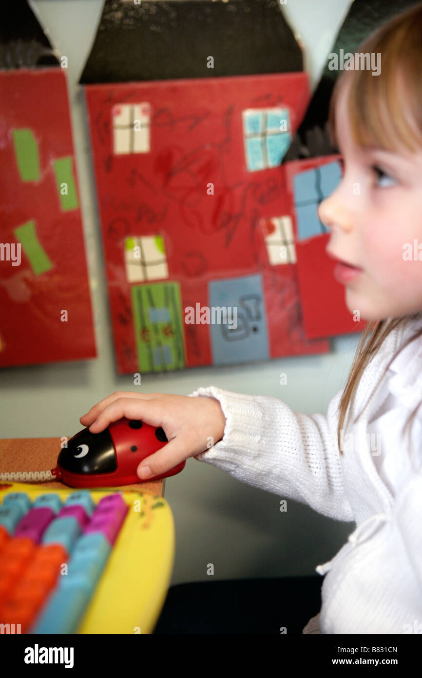primary school pupil holding mouse and working on computer Stock Photo ...