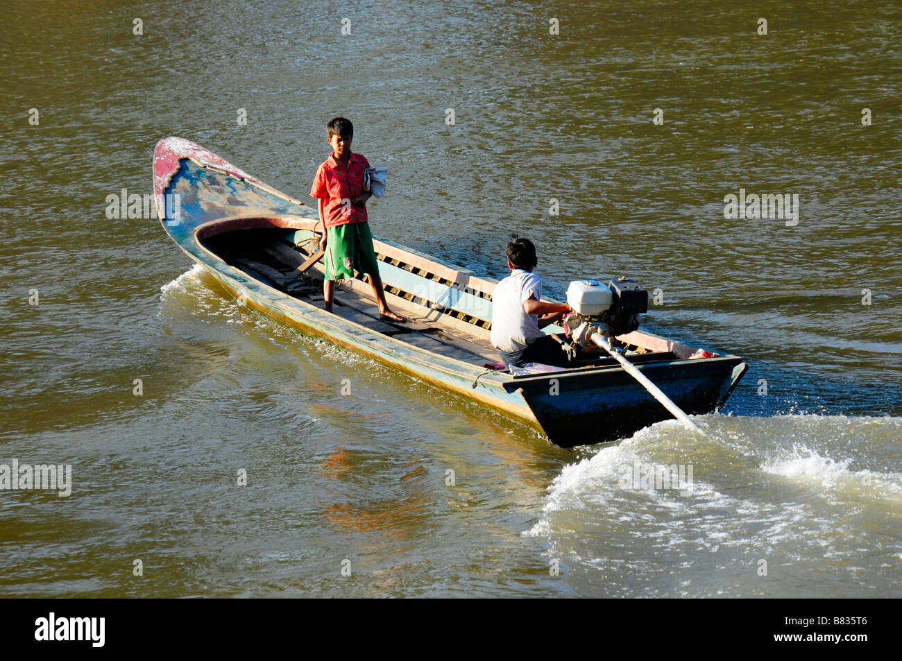 Burmese kids driving long tail boat crossing Moei river from Burmese ...