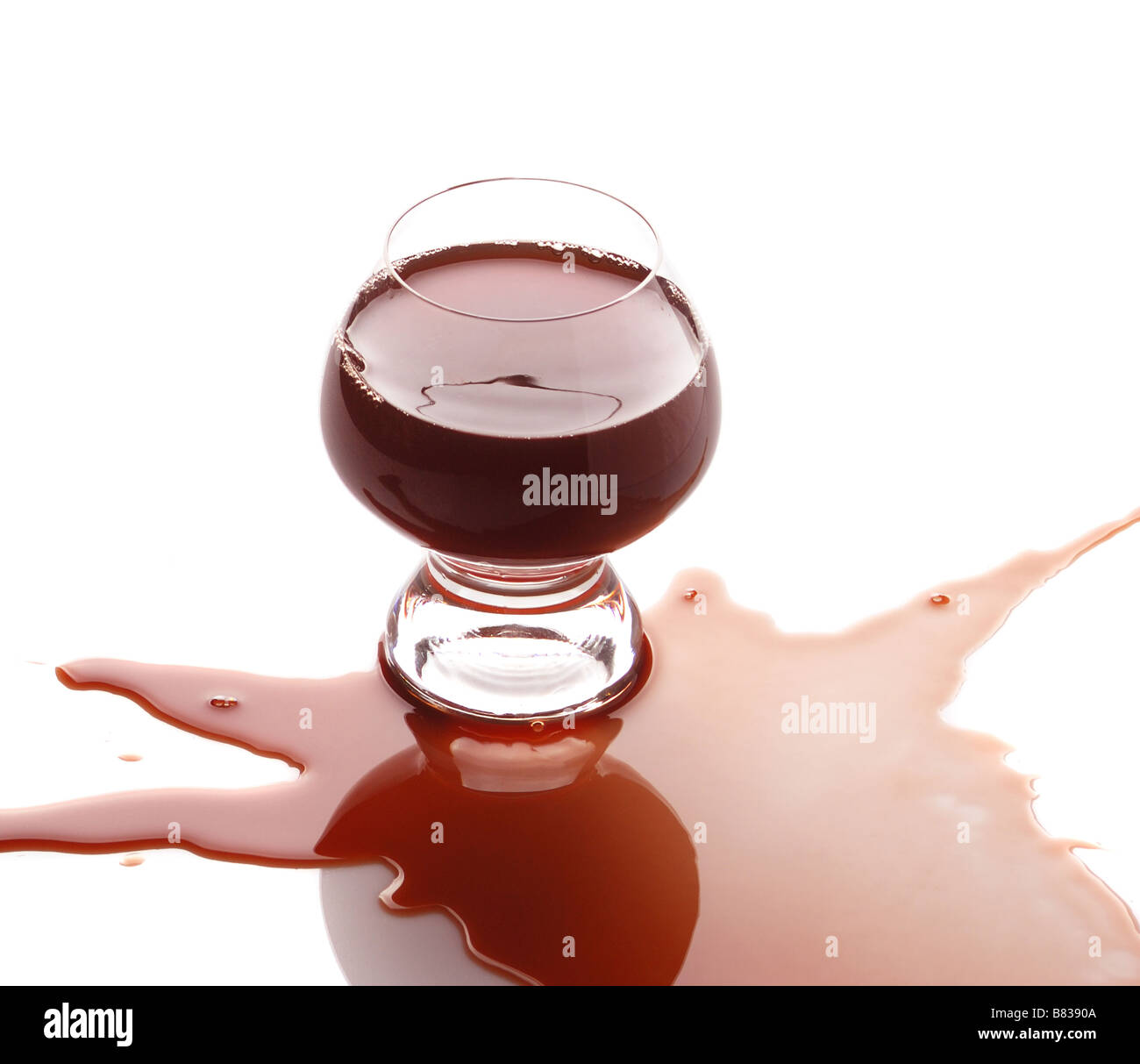 The spilled red wine Wine poured on a surface is isolated on a white ...