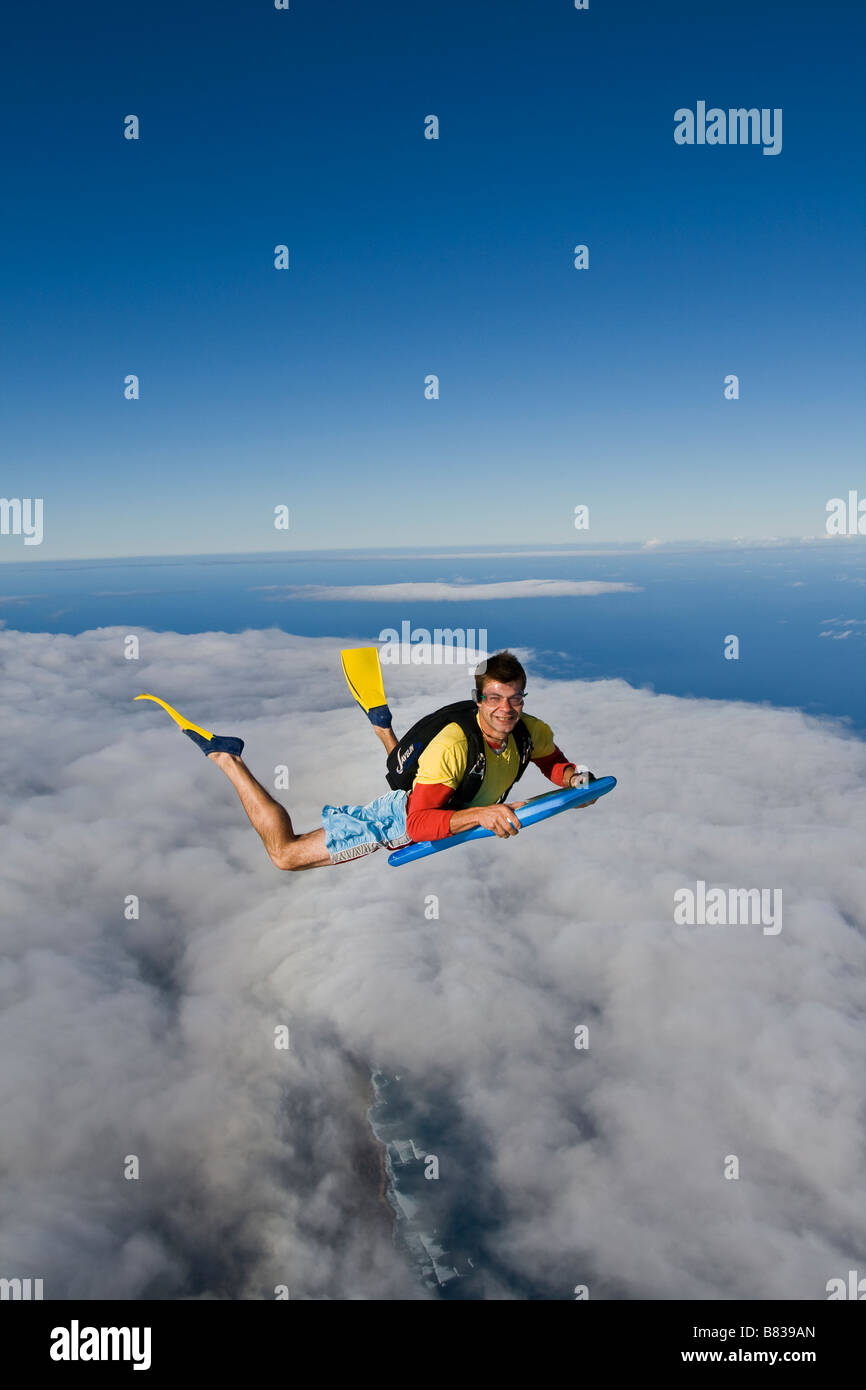 Skydiver is riding the big wave in the sky with a body board over the ...