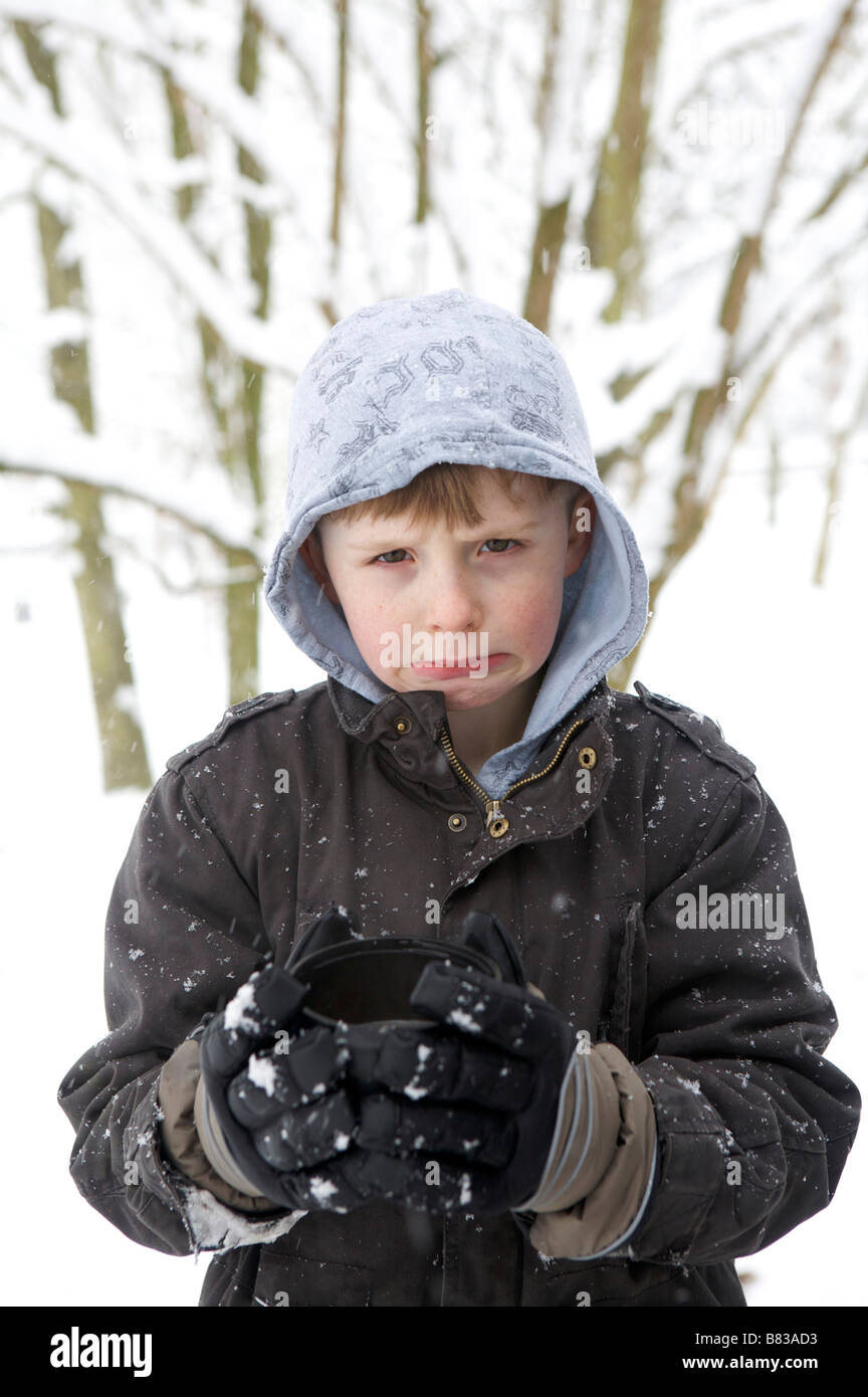 Heavy snow creates a winter wonderland, London. Cold child tries to ...
