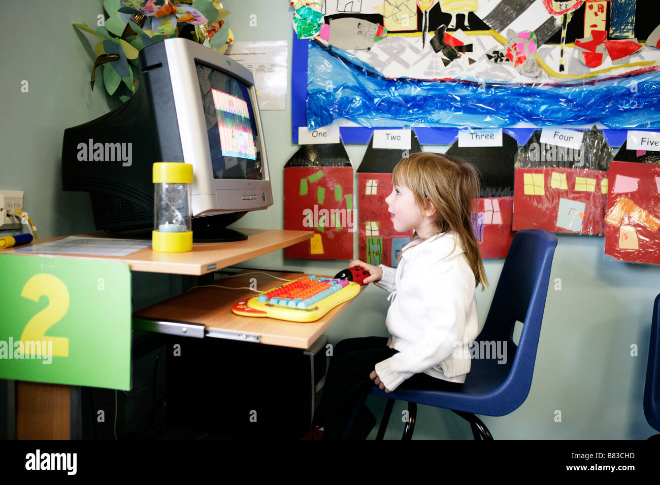 primary school pupil holding mouse and working on computer Stock Photo ...