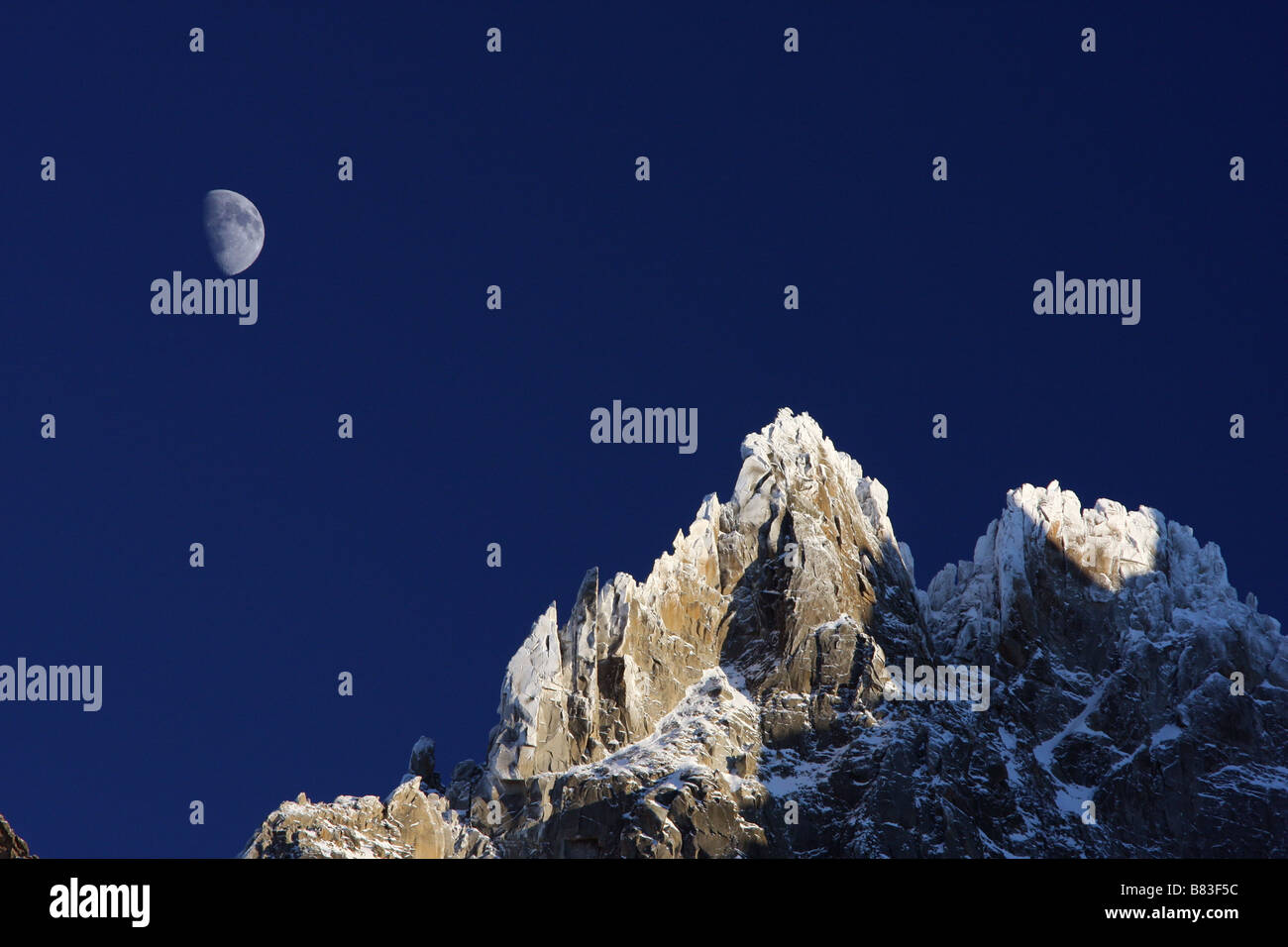 Mountain peak with snow and the moon hi-res stock photography and ...