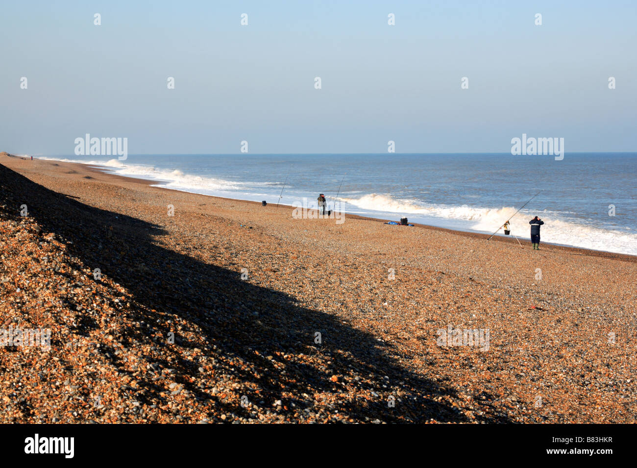 Shingle bank and beach with sea anglers at Salthouse, Norfolk, UK Stock ...