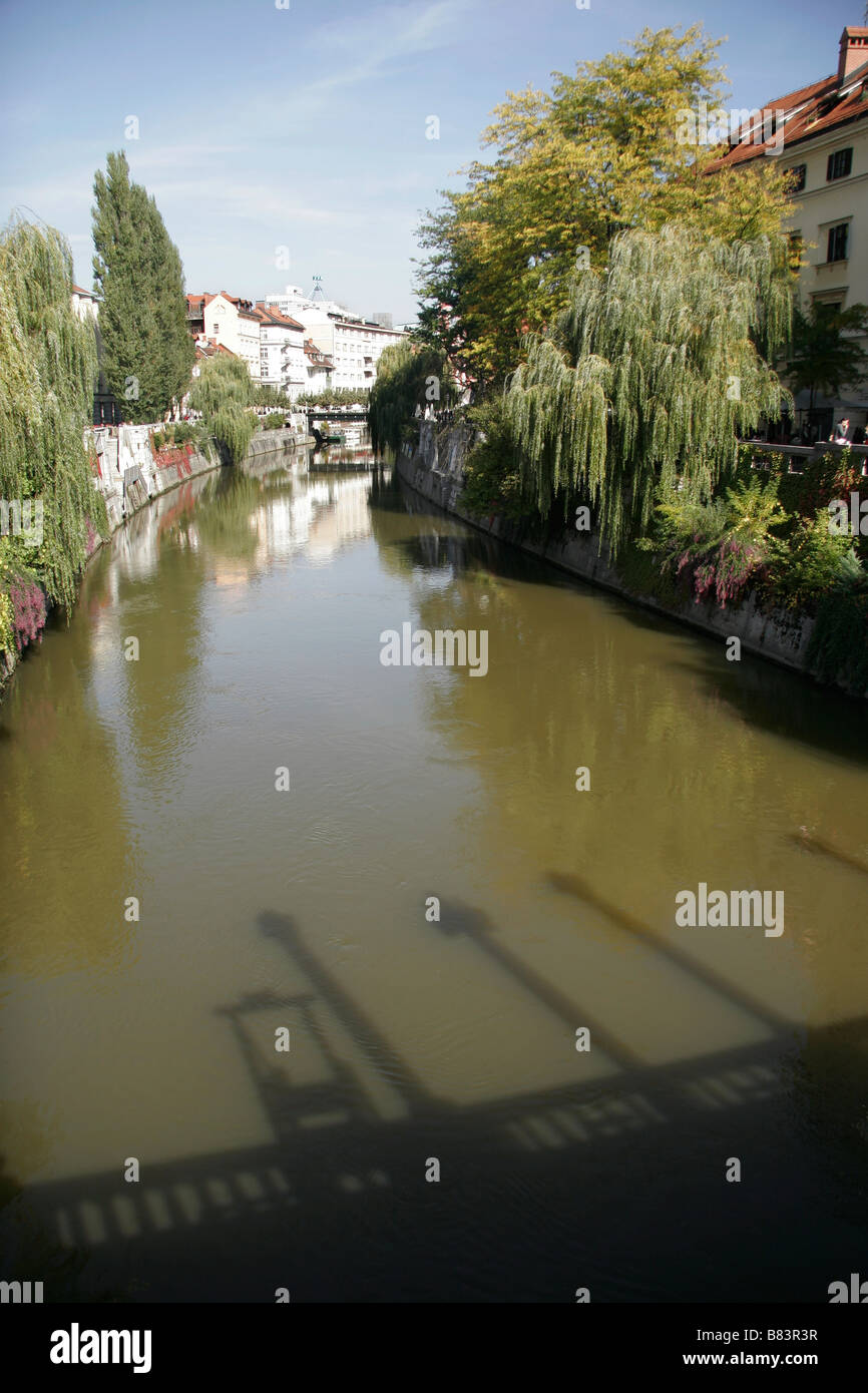 Cobbler's Bridge (Cevljarski Most) shadow over the Ljubljanica river in ...