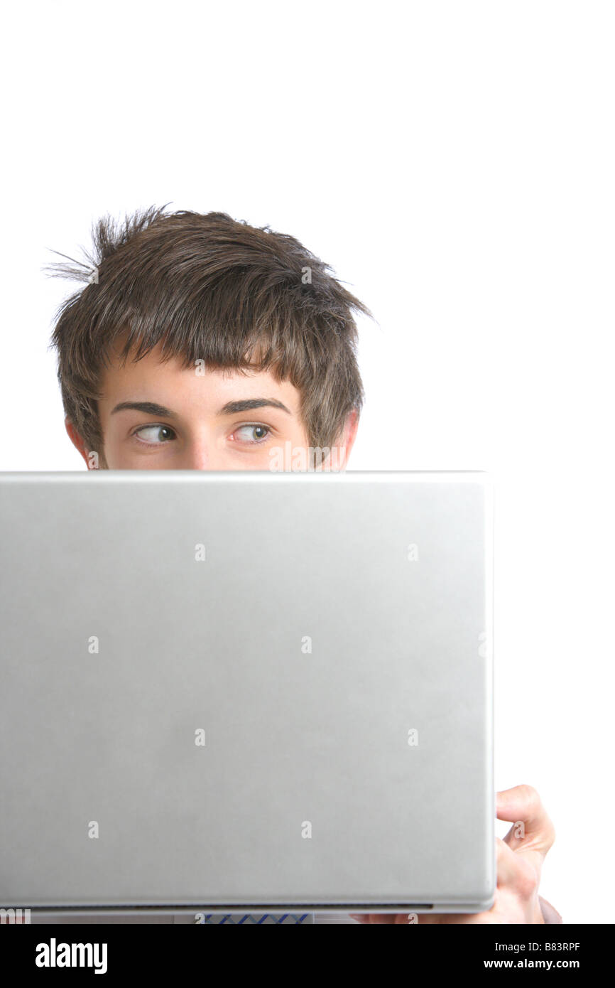 A business man peeking over a modern laptop in the studio Stock Photo ...