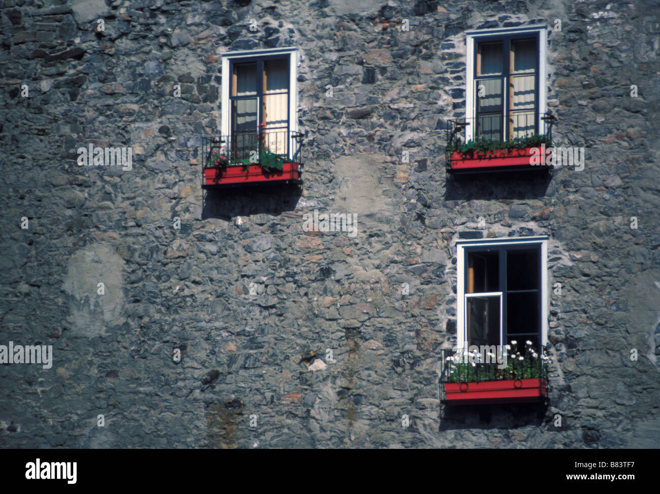 three windows on side of building Stock Photo - Alamy
