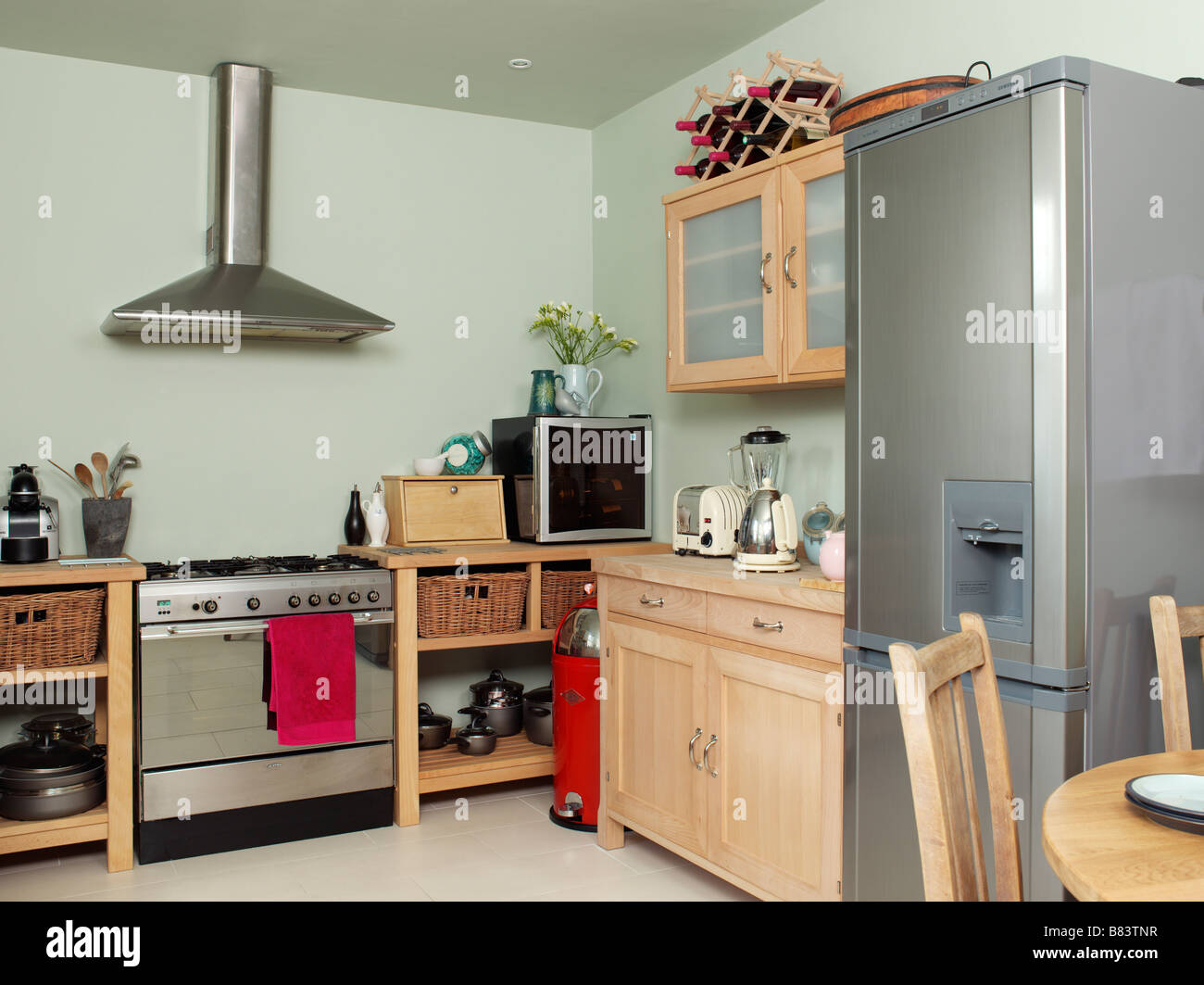 modern styled kitchen with range cooker and pan storage shelves with ...