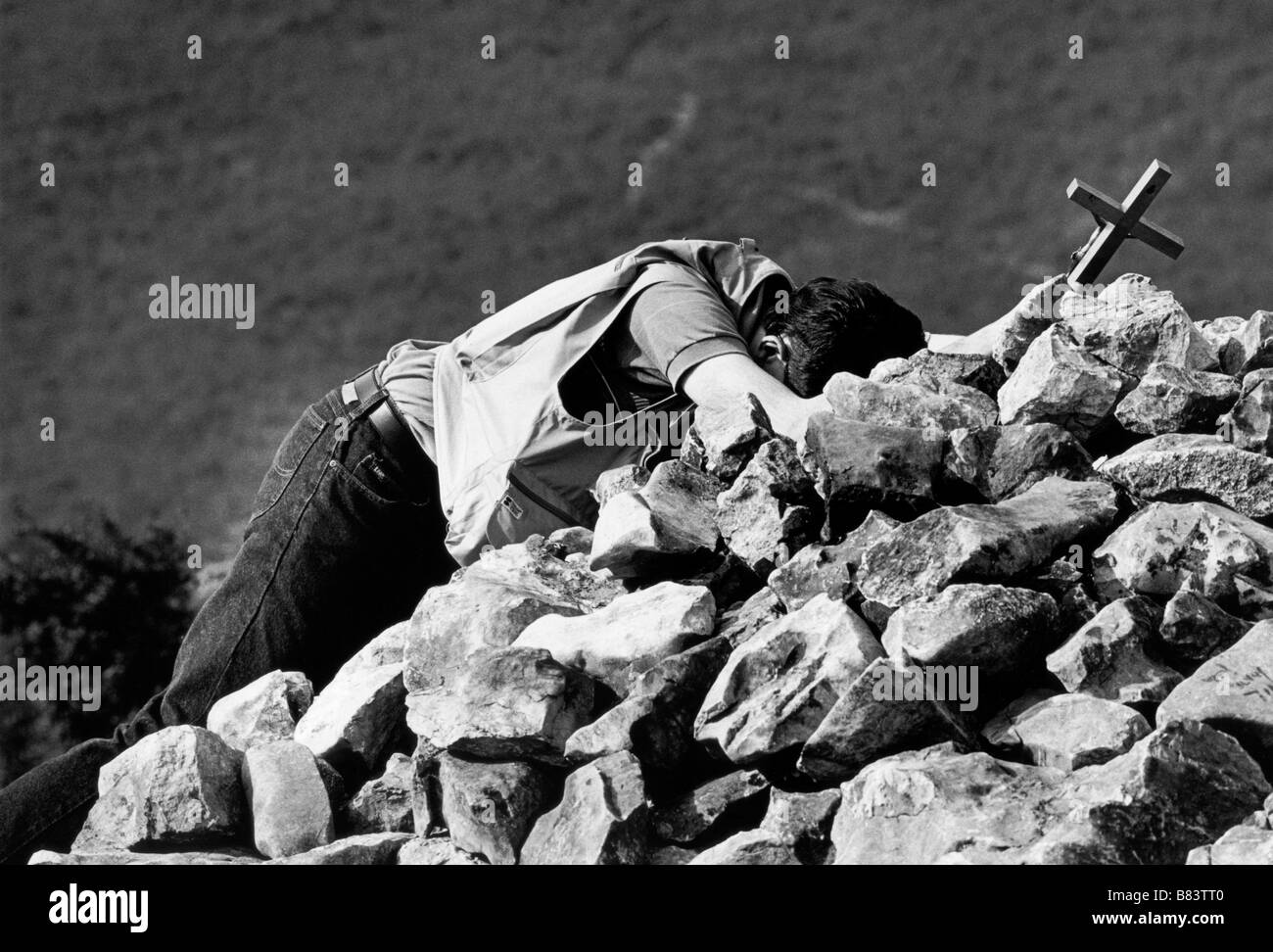 Man prays clutching a cross at the site of the vison of the Virgin on ...