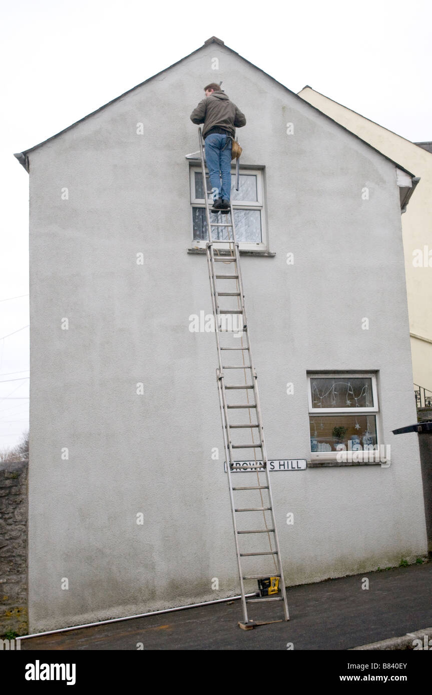 Workman on a ladder hi-res stock photography and images - Alamy