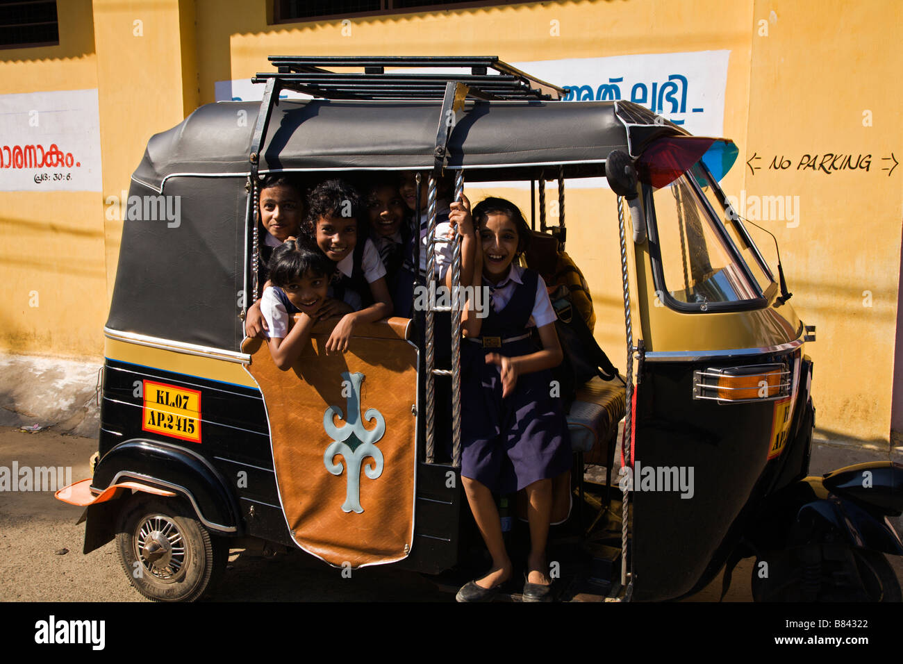 Schoolgirls waiting in their three wheeler school taxi in Fort Cochin ...