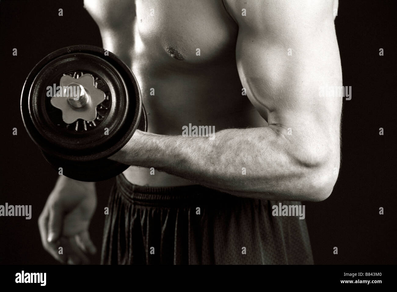 Man working out with hand weights Stock Photo - Alamy